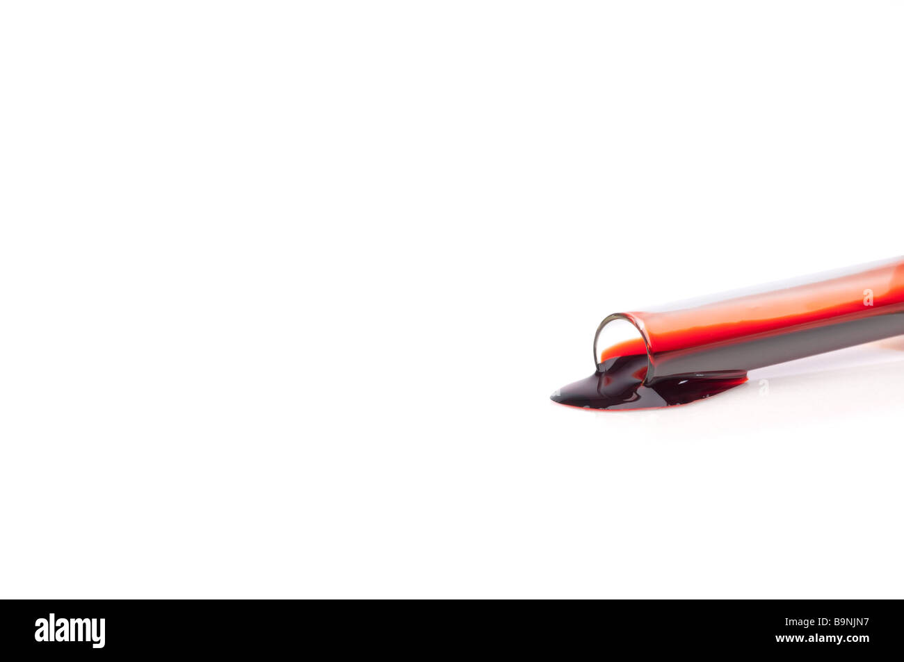 Red blood spilling from a test tube on a reflective white surface Stock ...