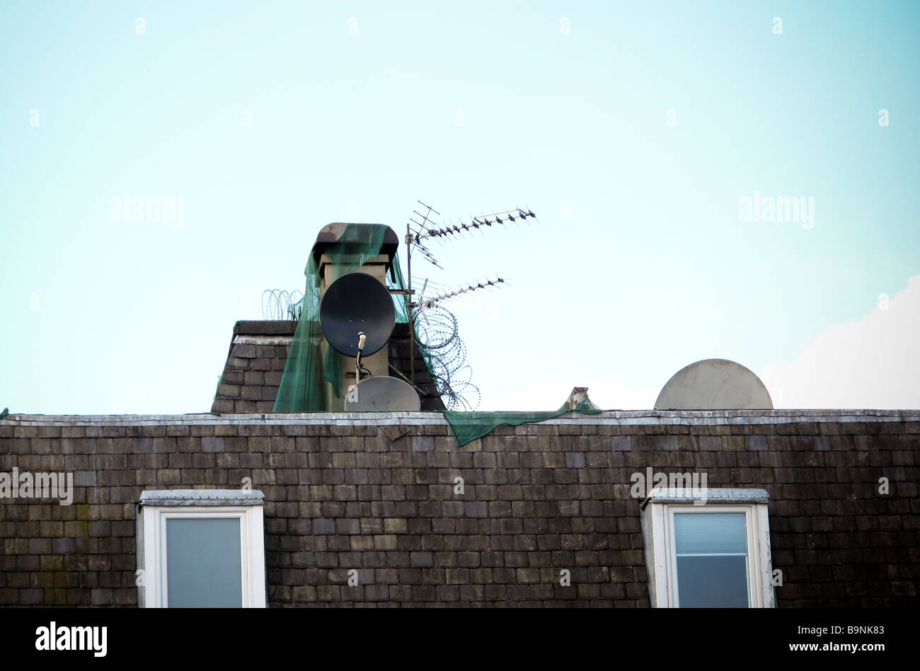Satellite dishes and aerials on roof Stock Photo - Alamy
