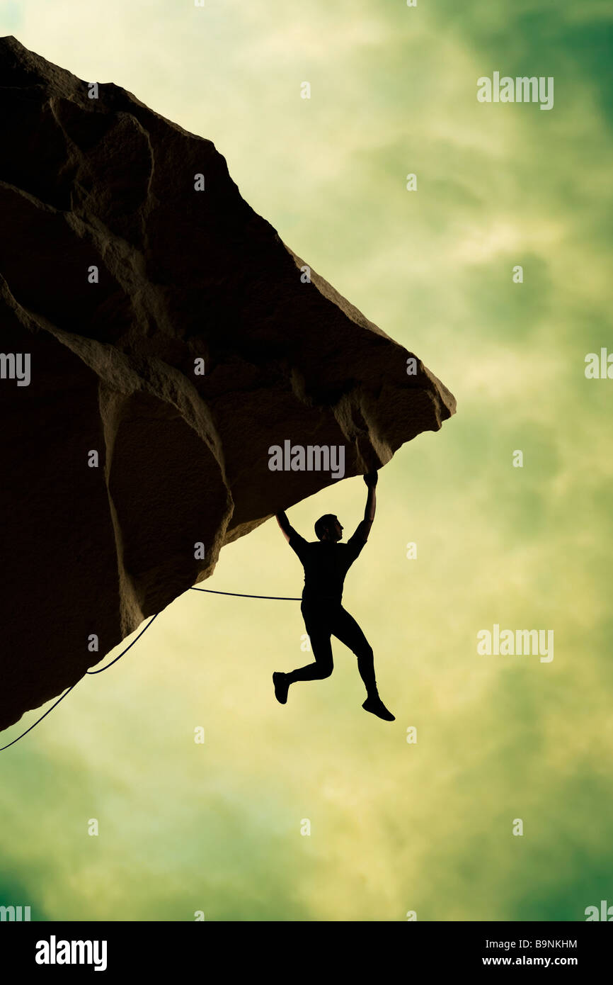 Silhouette of mountaineer on mountain overhang, side view Stock Photo ...