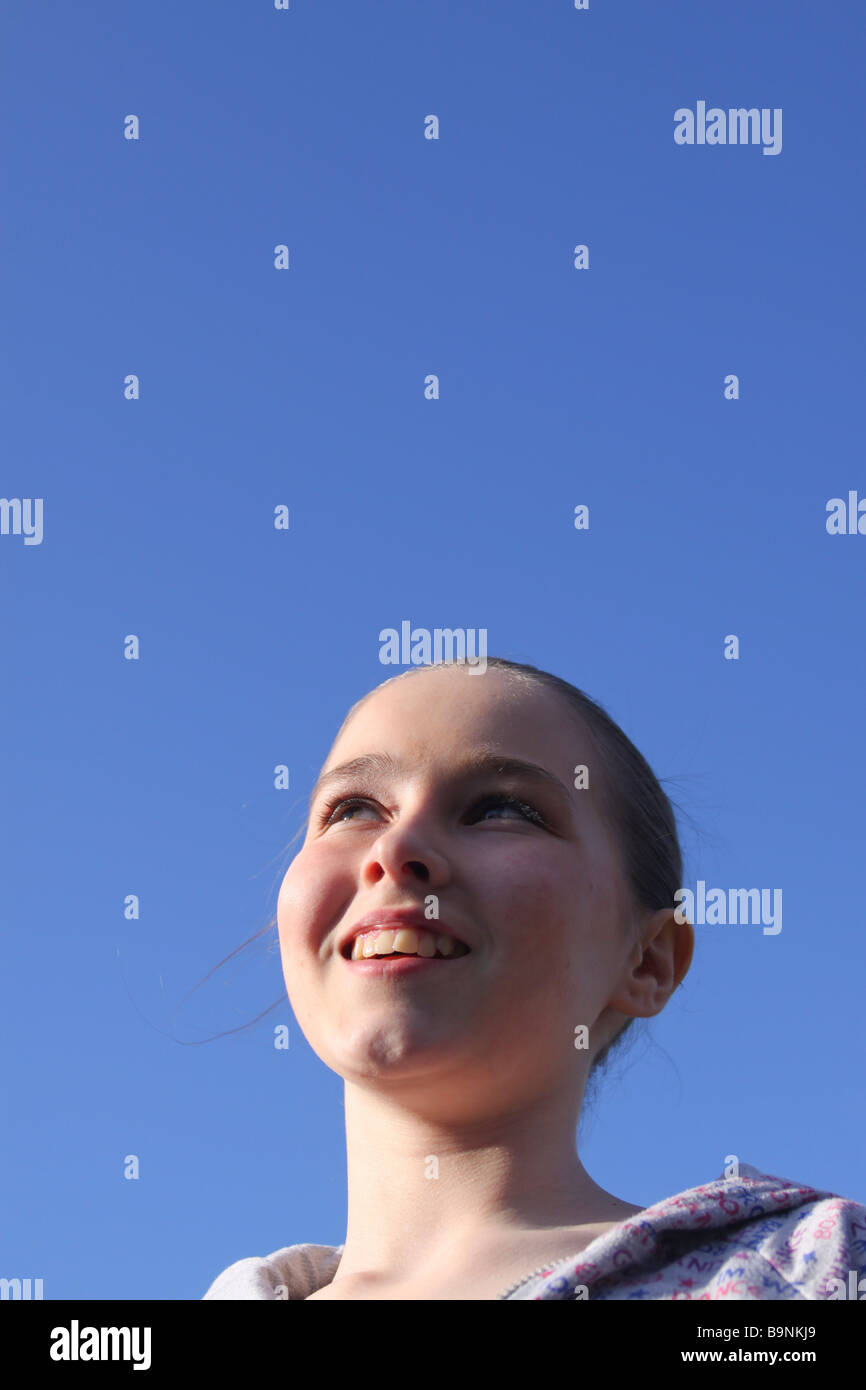Young girl looking happy up at blue sky Stock Photo - Alamy