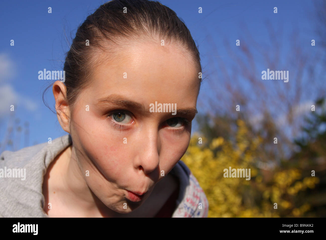 Young girl making funny face to camera Stock Photo - Alamy