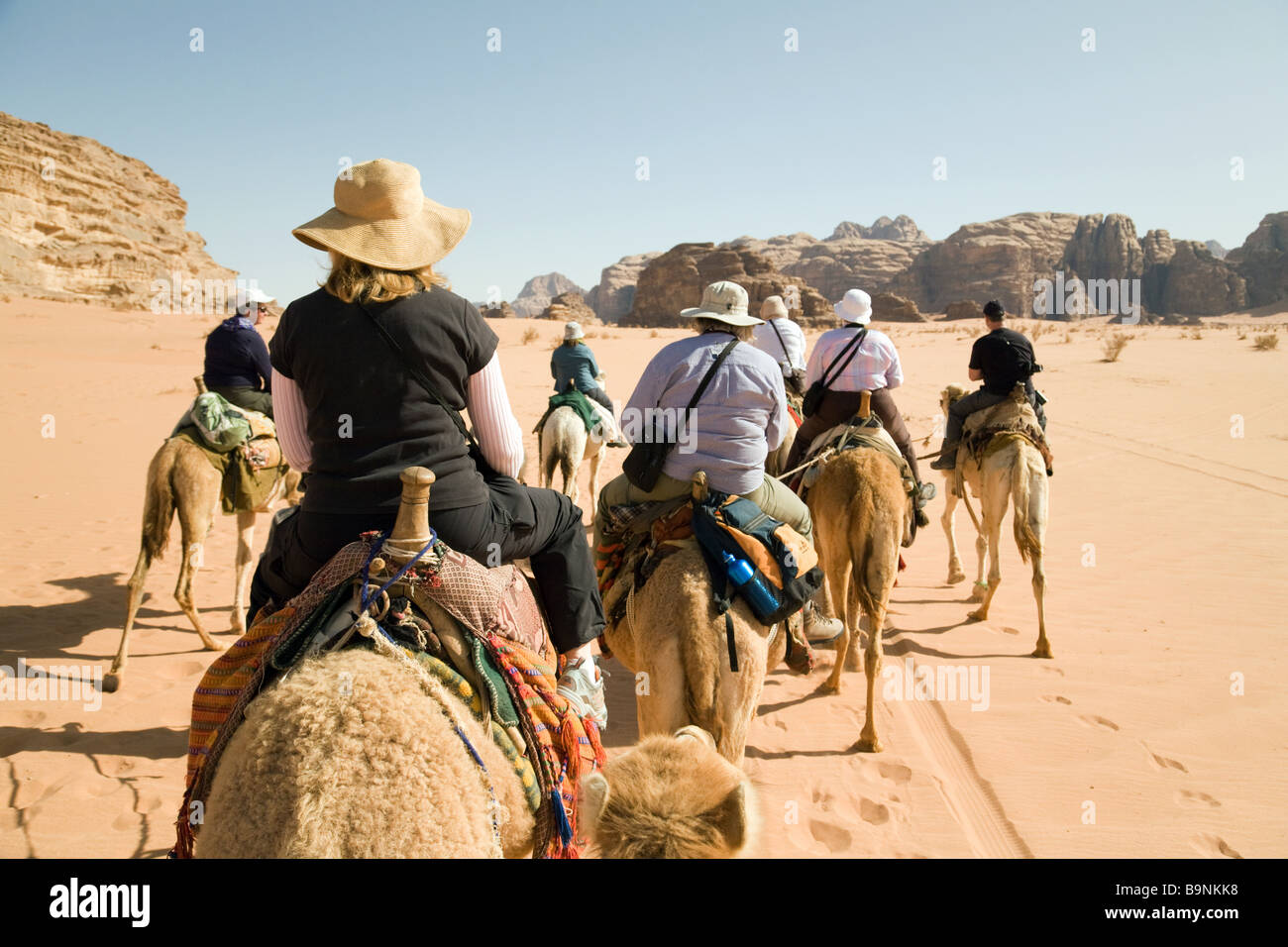 A group of tourists riding off into the desert, Wadi Rum, Jordan Stock ...