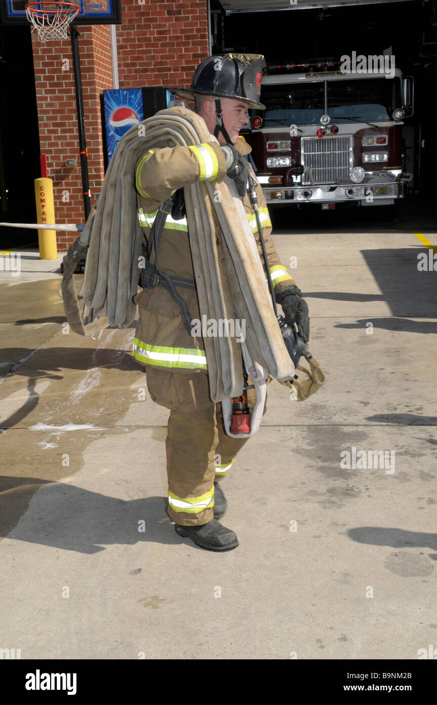 firefighter carrying hose on his shoulder in Bladensburg, Maryland ...