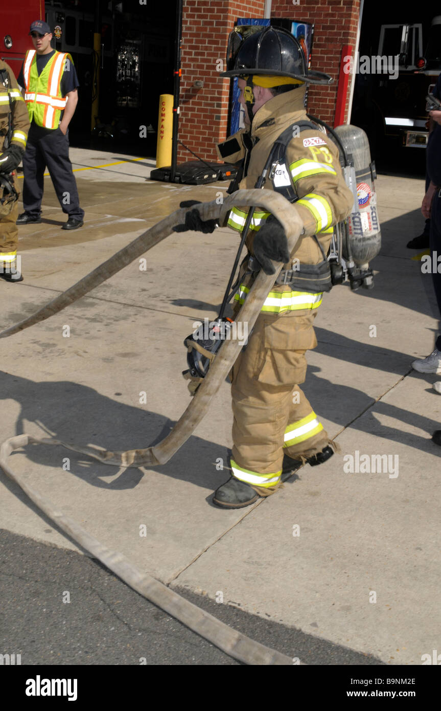 firefighter carrying hose on his shoulder in Bladensburg, Maryland ...