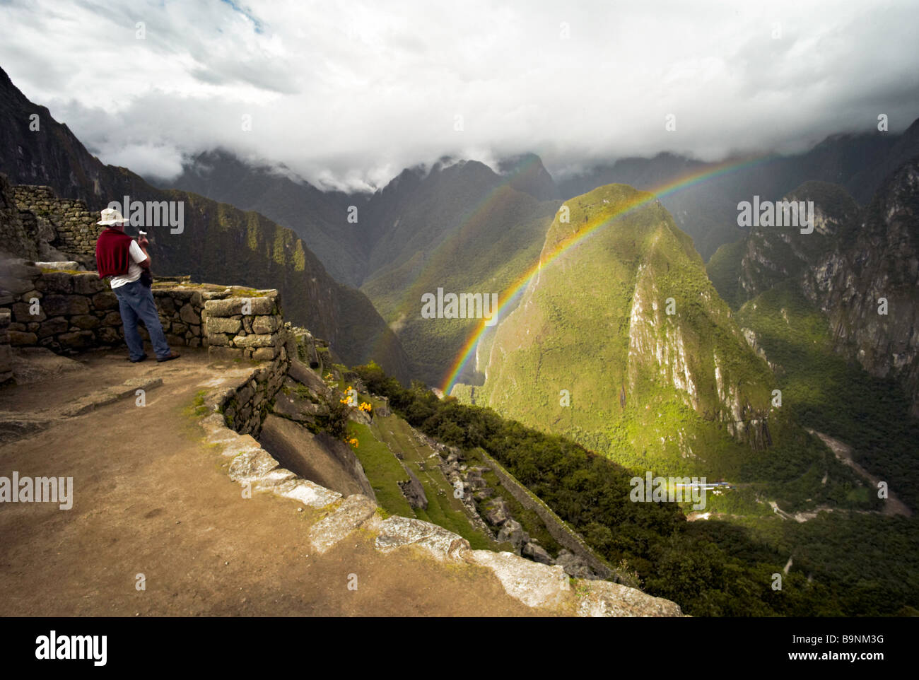 PERU MACHU PICCHU Tourist photographs double rainbows over the ancient ...