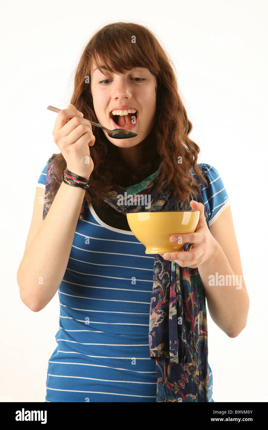 Girl eating from bowl Stock Photo - Alamy