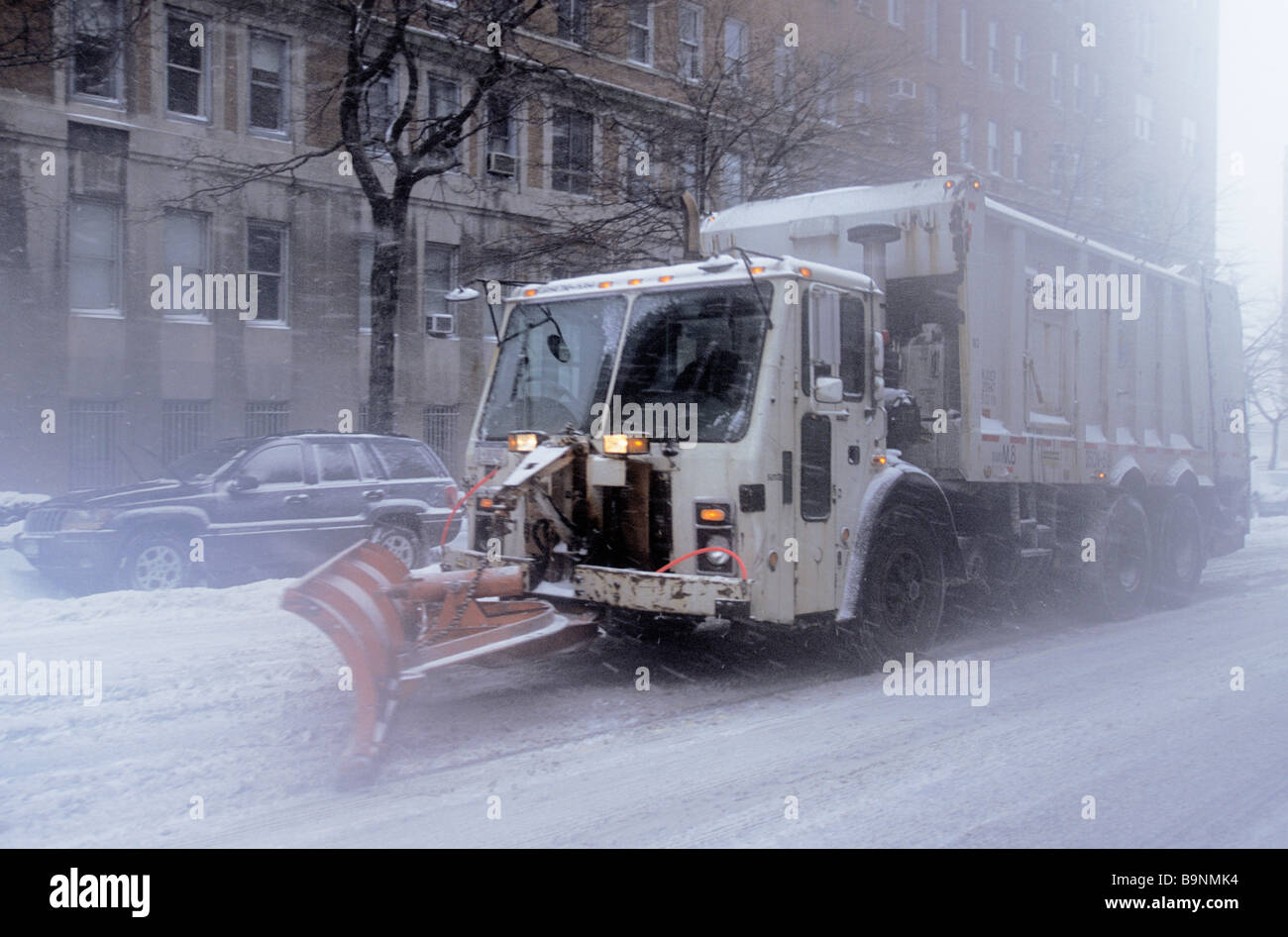 Snow plow clearing street during a blizzard in New York City. Snowstorm ...