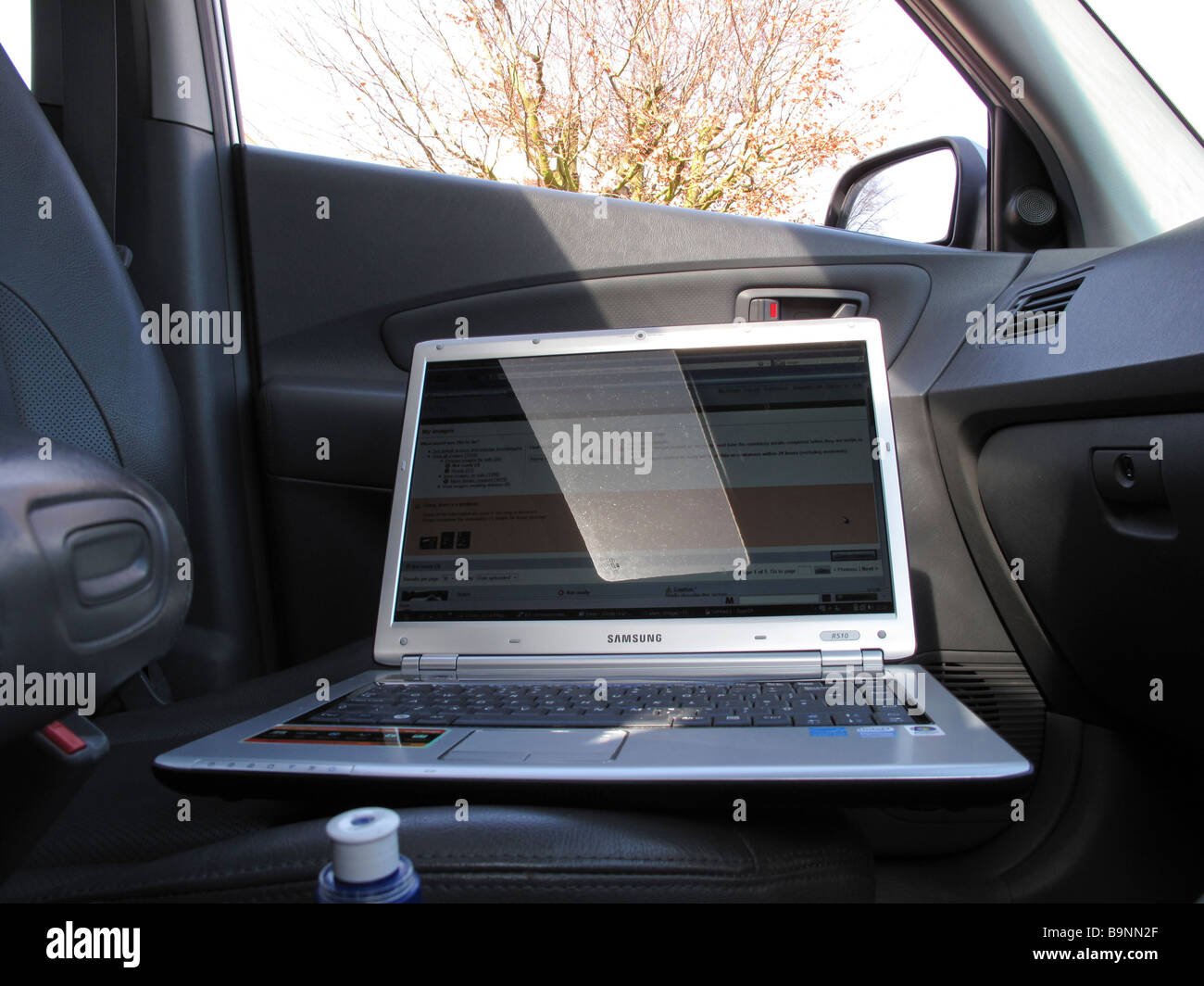 Laptop computer being used in car Stock Photo - Alamy