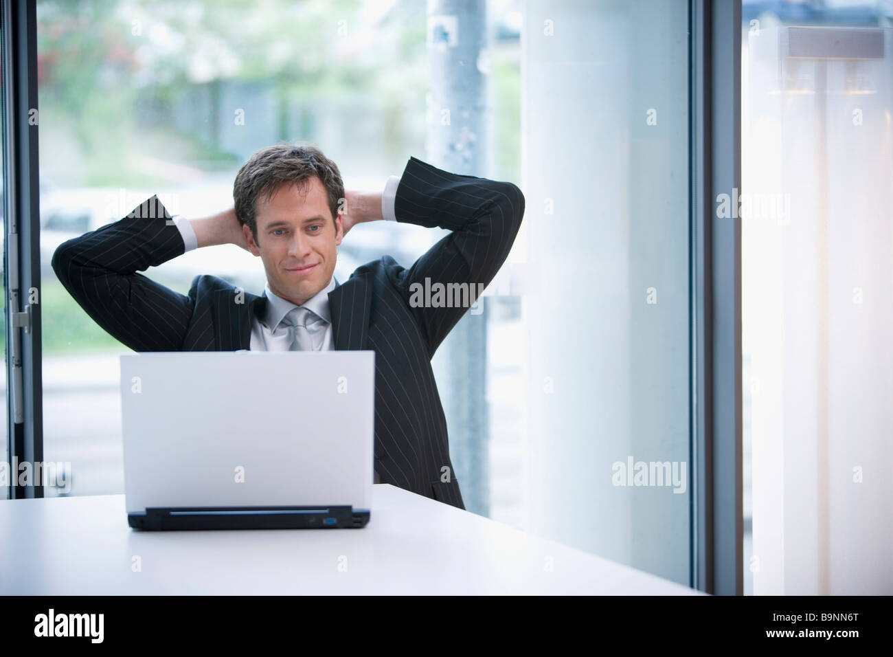 content businessman looking at screen of laptop computer Stock Photo ...