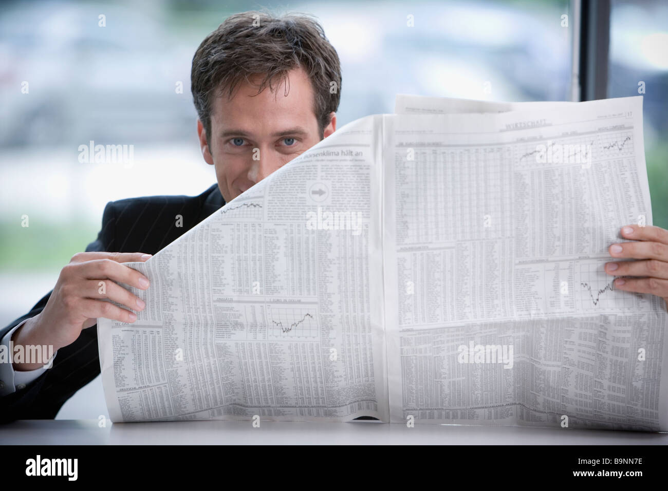 Hiding behind newspaper hi-res stock photography and images - Alamy