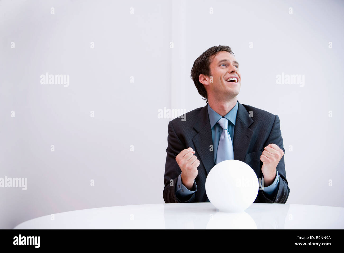 portrait of businessman with crystal ball celebrating success Stock ...