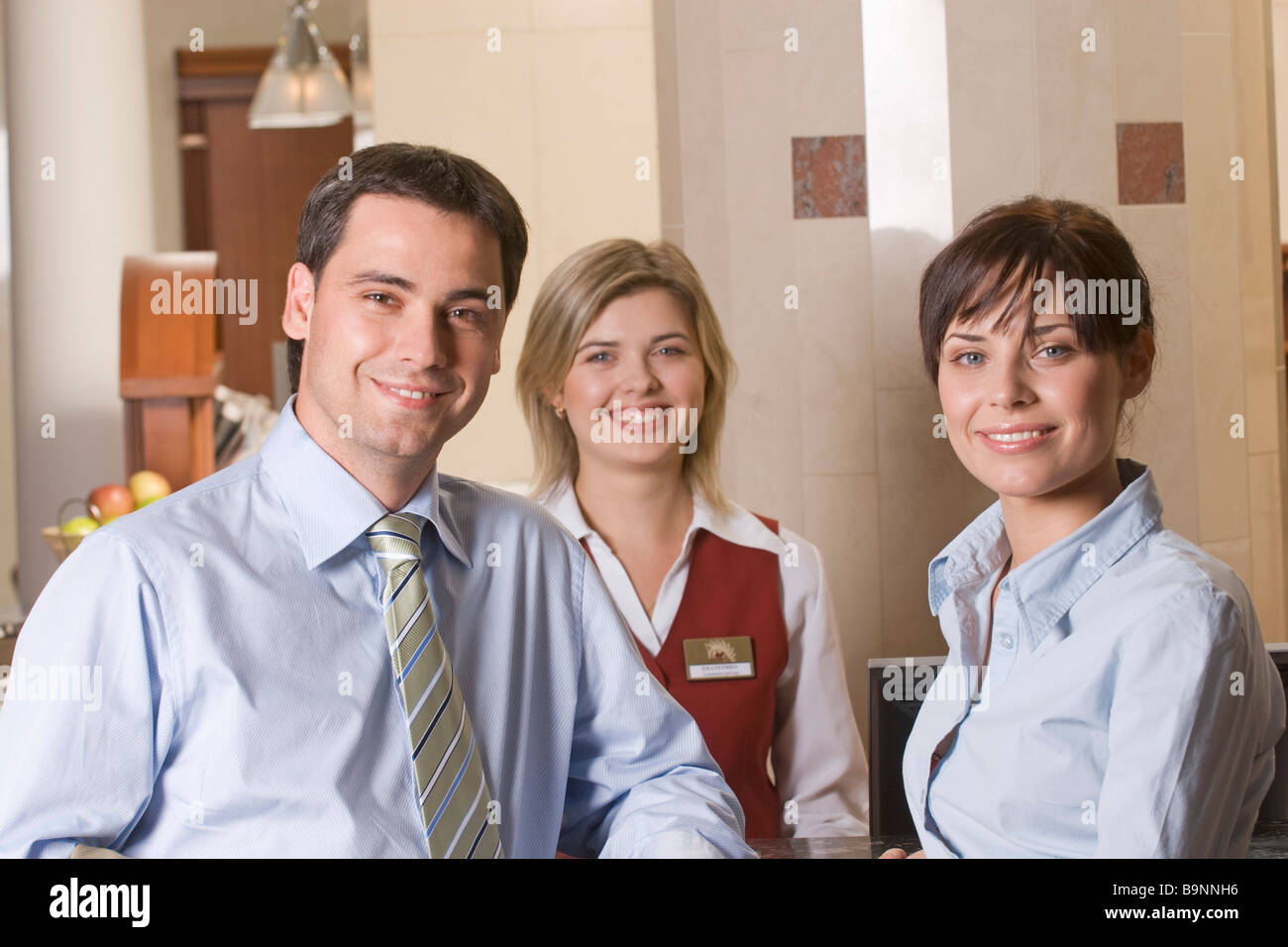 portrait of three smiling members of hotel staff Stock Photo - Alamy