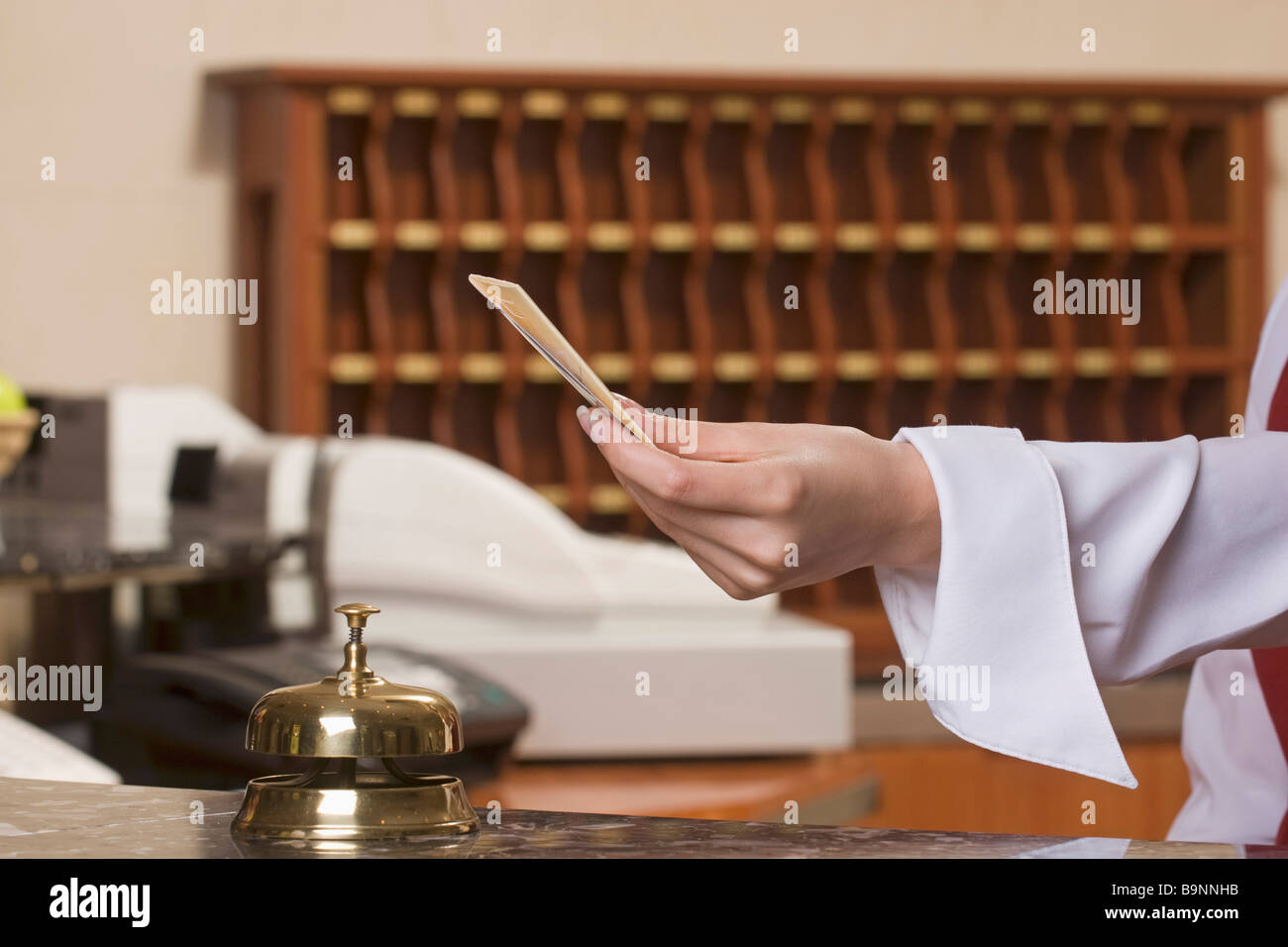 close-up of hotel receptionist holding key card Stock Photo - Alamy