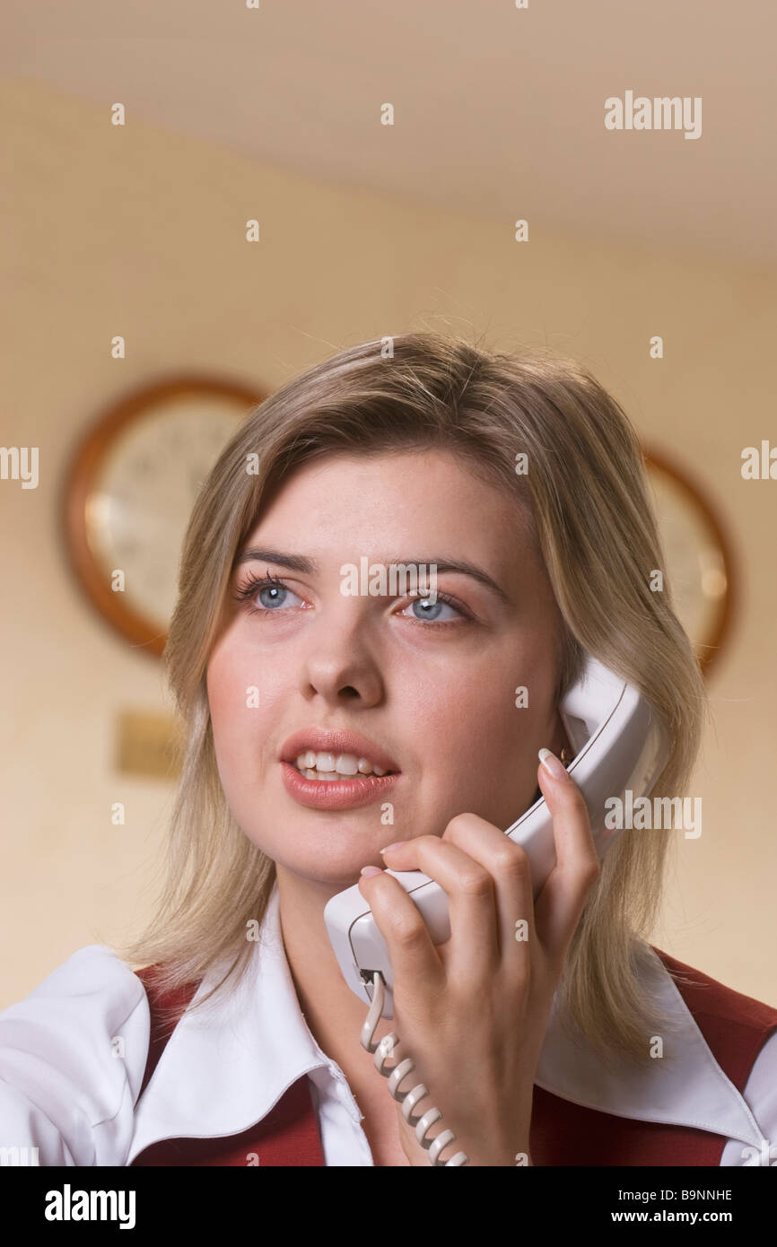 Female hotel receptionist talking on telephone hi-res stock photography ...