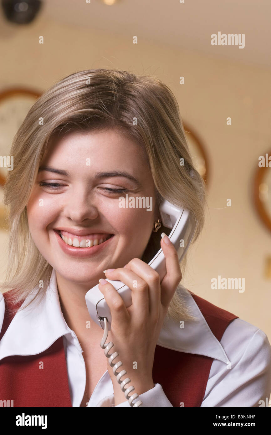headshot of young hotel receptionist talking on telephone Stock Photo ...