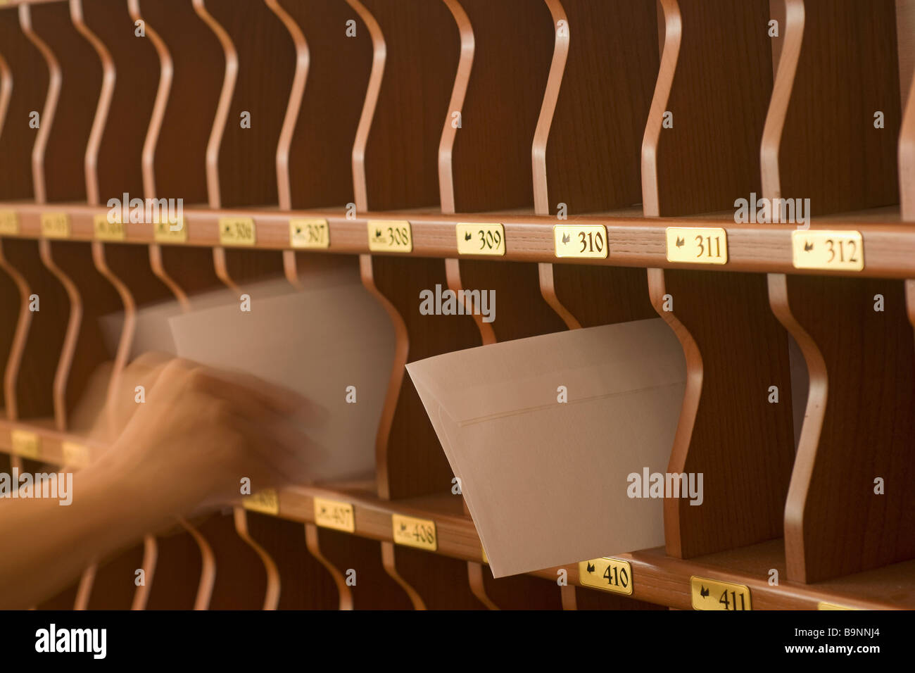 hand putting letters into pigeon holes at hotel reception Stock Photo ...