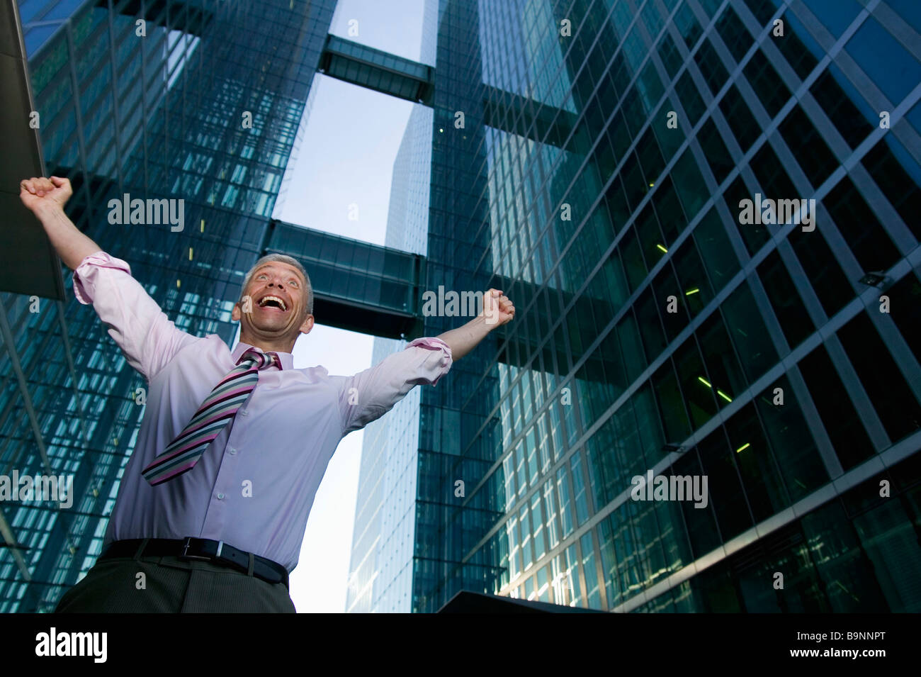 low angle portrait of mature businessman in front of office building ...