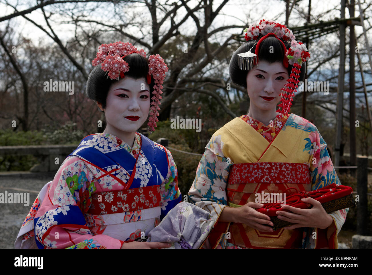 Two Maiko (trainee Geisha) pose for the camera in Kyoto, Kansai, Japan ...