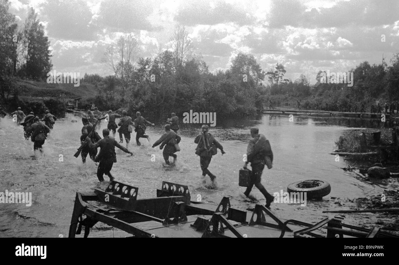 Soviet soldiers crossing a river pursuing the retreating Nazis near the ...