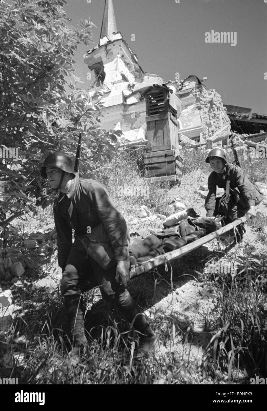 Two Soviet soldiers carrying their comrade wounded near Leningrad Stock ...