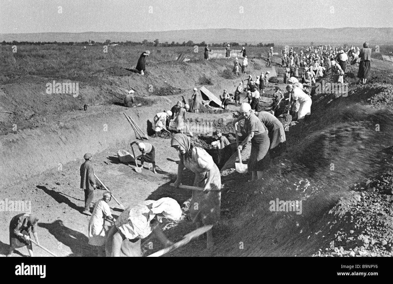 Caucasian digging anti tank trenches Stock Photo - Alamy