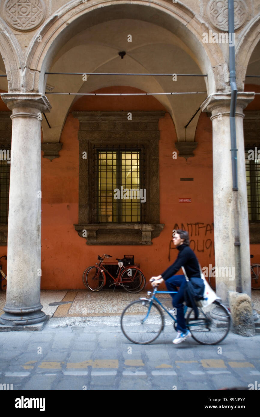 A girl cycles through the streets of the University district Bologna ...