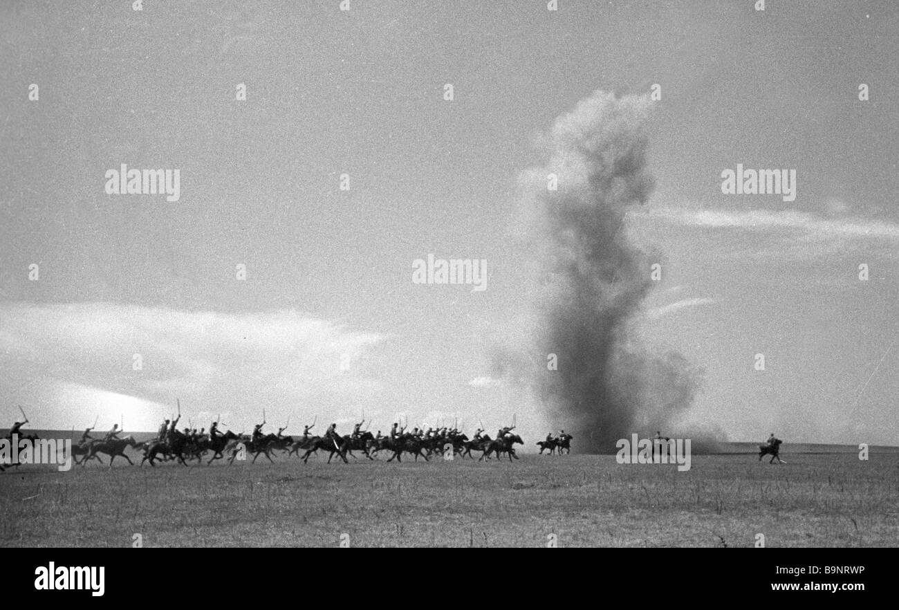 A cavalry unit galloping across a field An explosion Stock Photo - Alamy