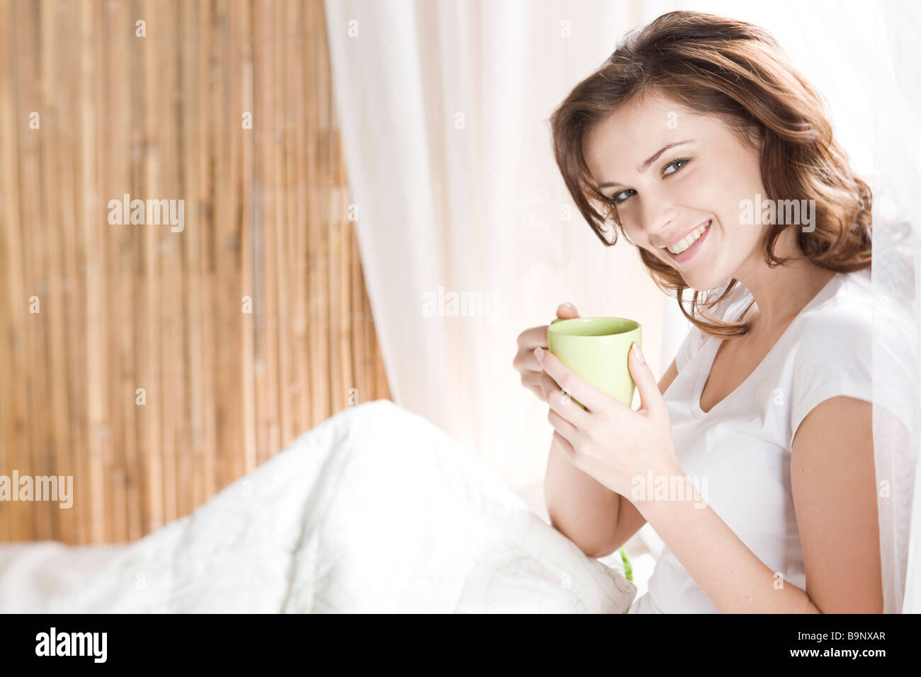 woman drinking morning coffee in bed Stock Photo - Alamy