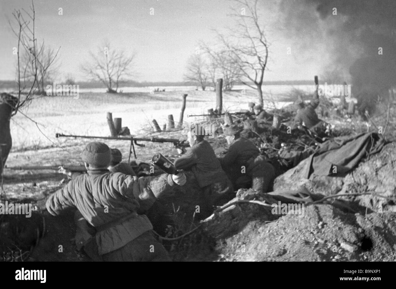 Soldiers shooting from a trench Stock Photo - Alamy