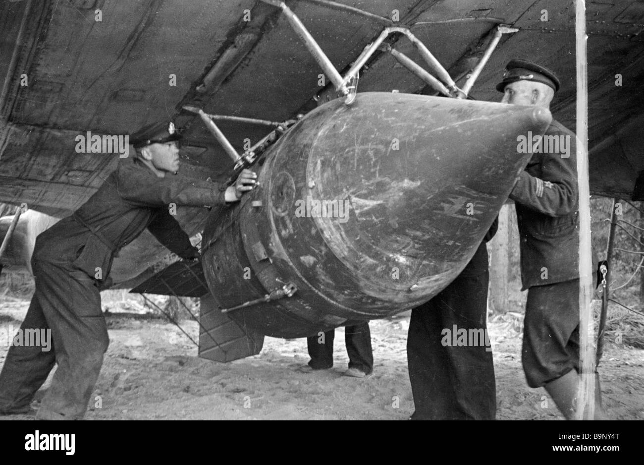 Soldiers loading a bomb on the plane before a flight Stock Photo - Alamy