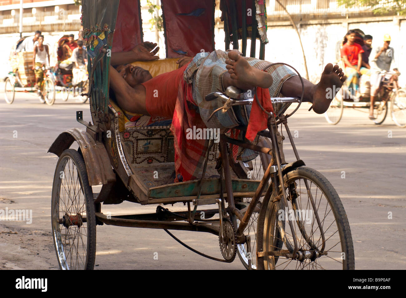 rickshaw bicycle hard work sleeping funny strange Stock Photo - Alamy