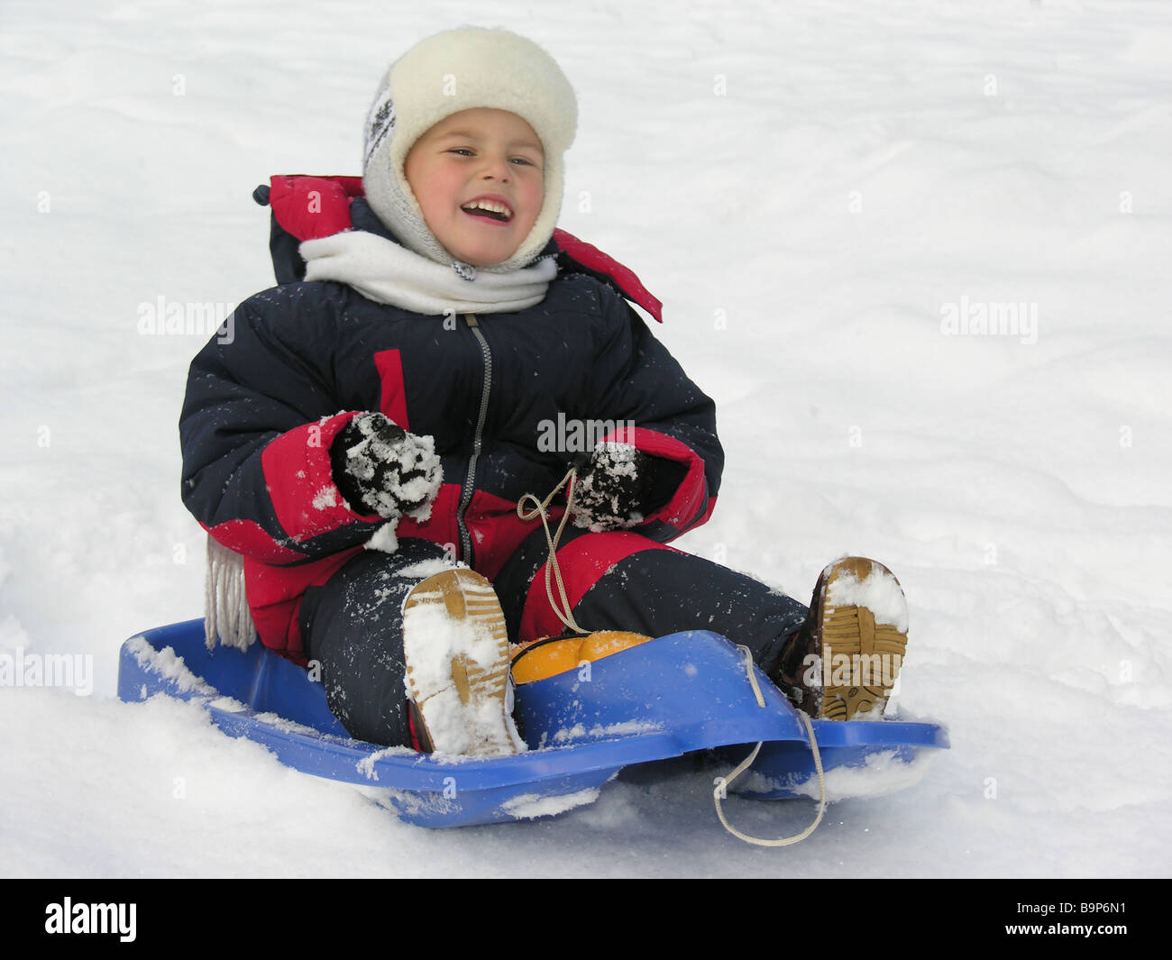 child on sled Stock Photo - Alamy