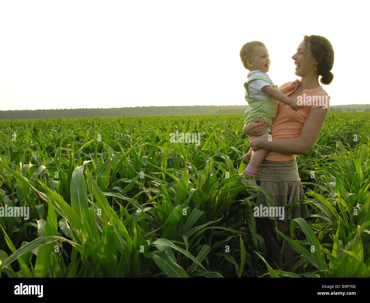 mother with baby in field Stock Photo - Alamy
