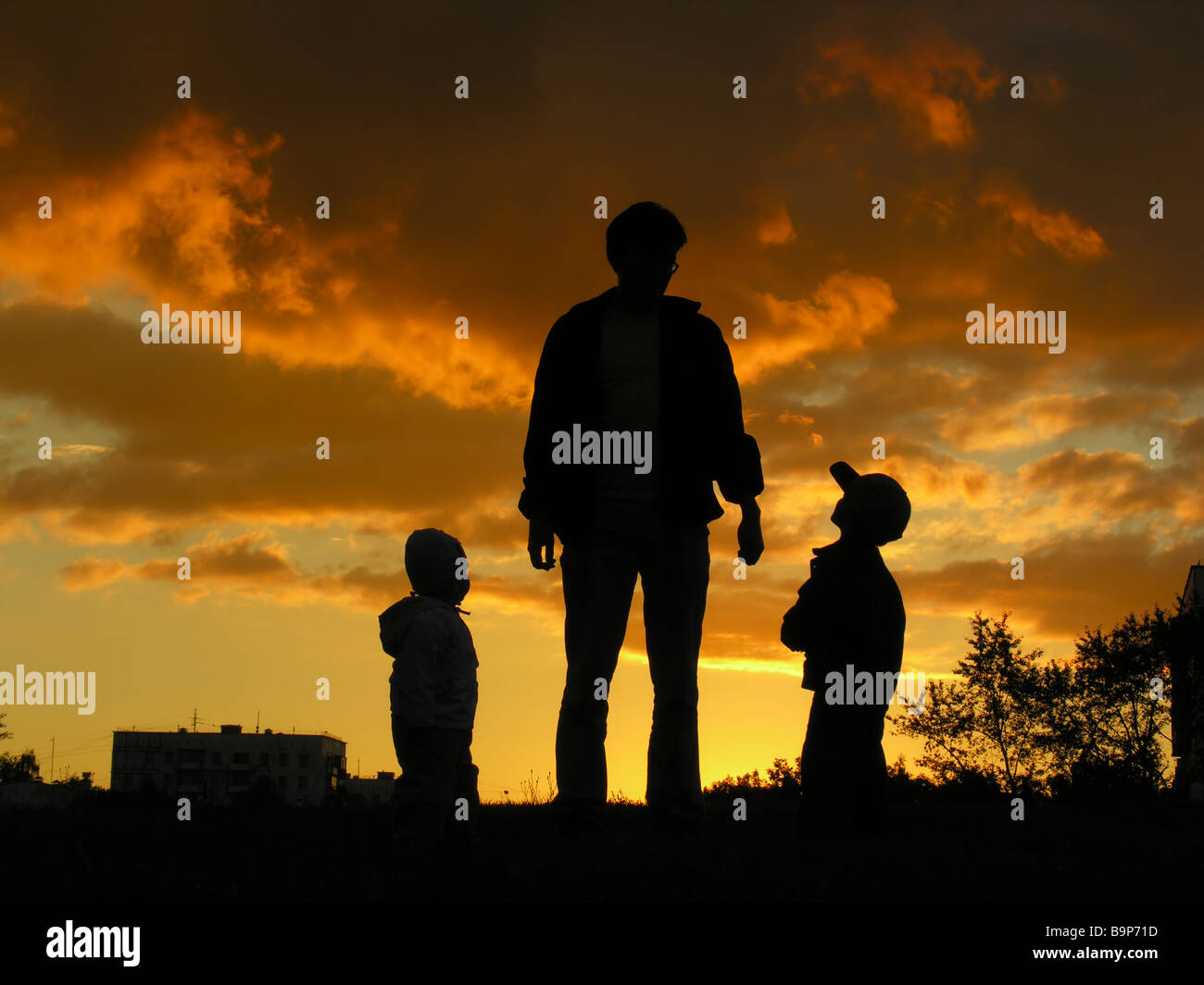 father with children sunset 2 Stock Photo - Alamy