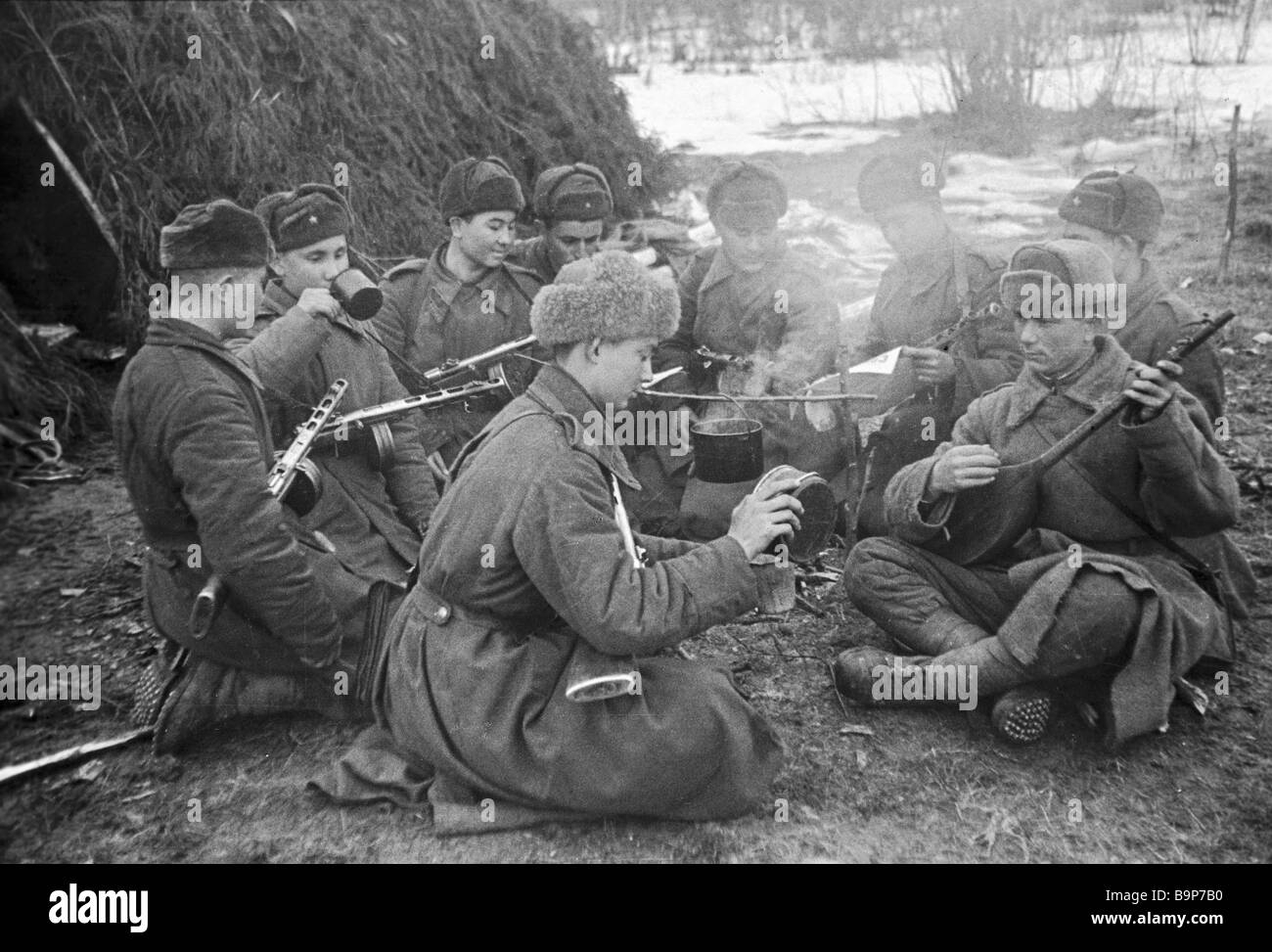 A group of Tajik soldiers listening to the dutar Stock Photo - Alamy