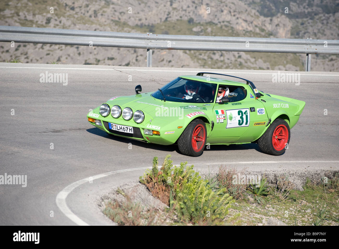 Green 1974 Lancia Stratos sports car racing in the Classic car rally ...