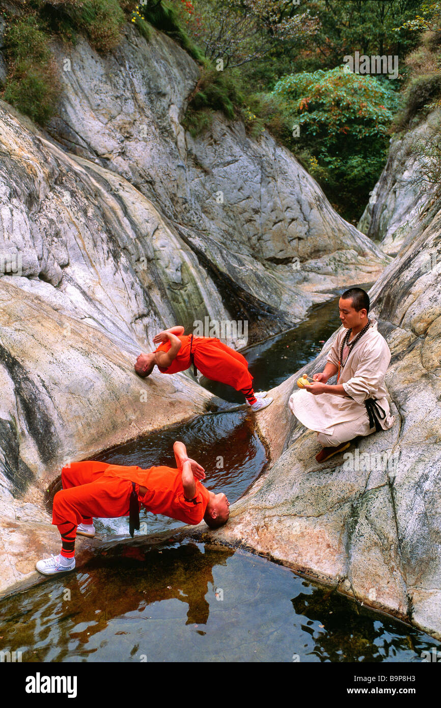 China, Henan province, Shaolin, Wushu master and disciples practising ...