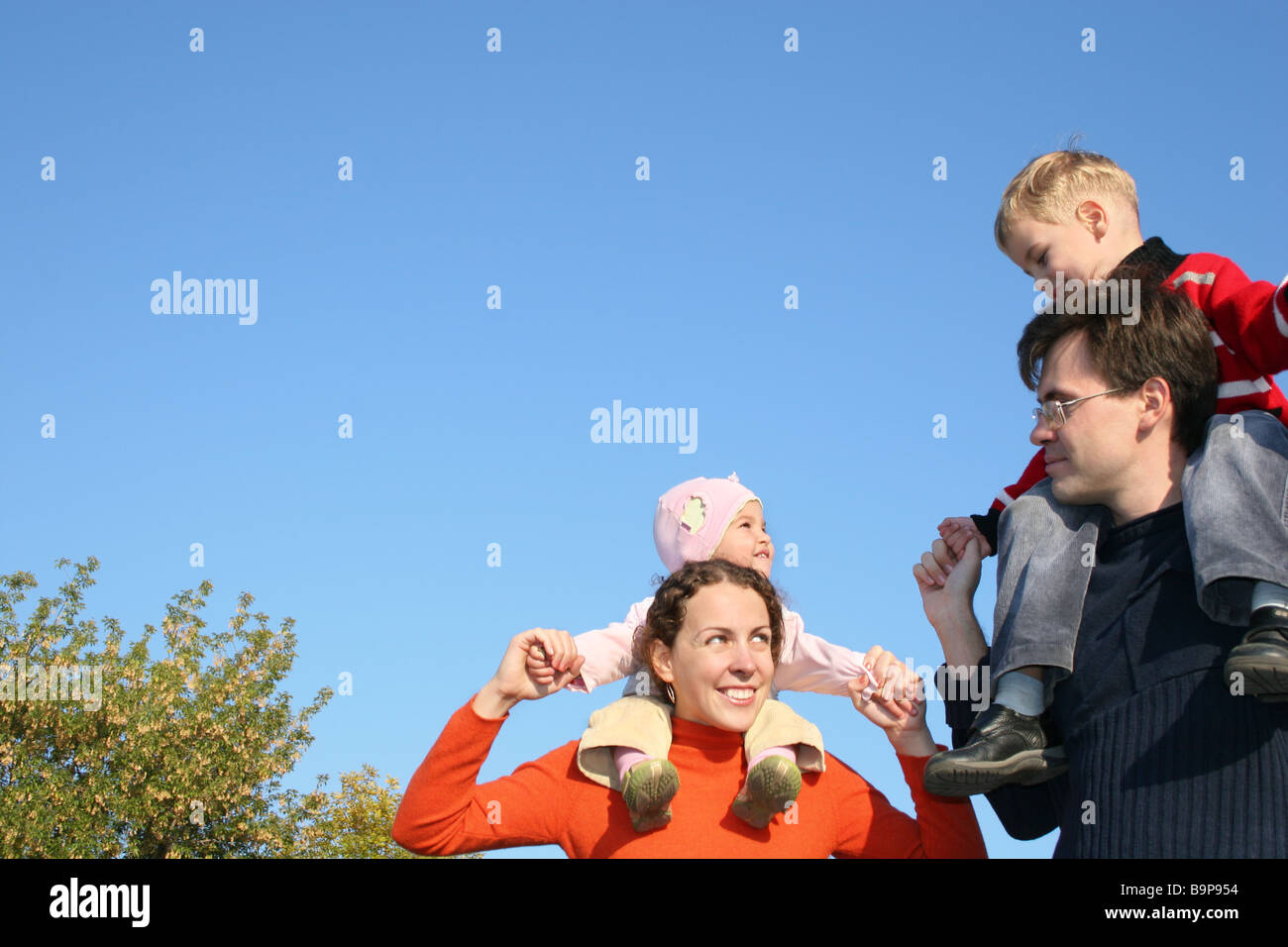 family with children on shoulders Stock Photo - Alamy
