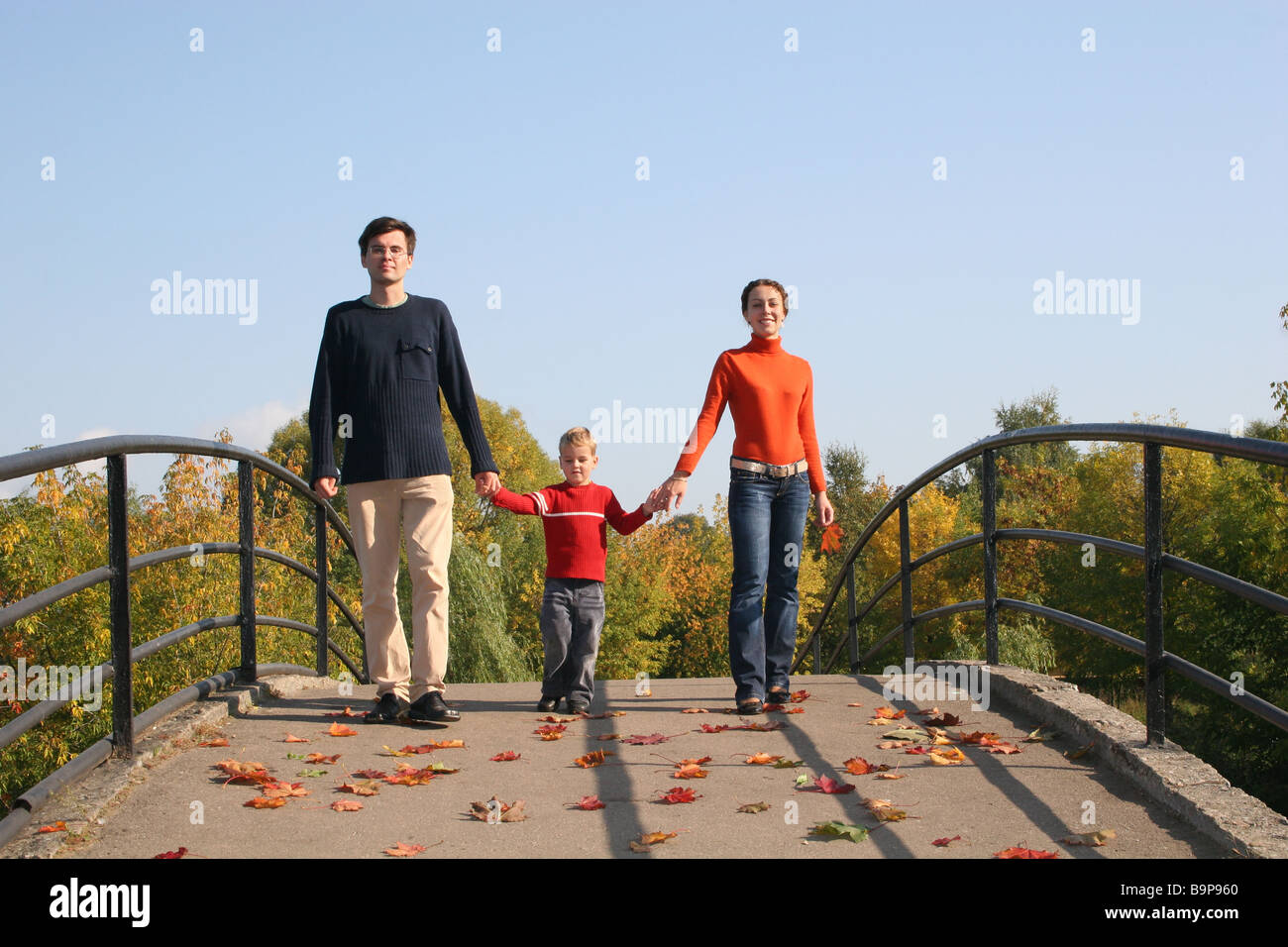 family with boy on autumn bridge Stock Photo - Alamy