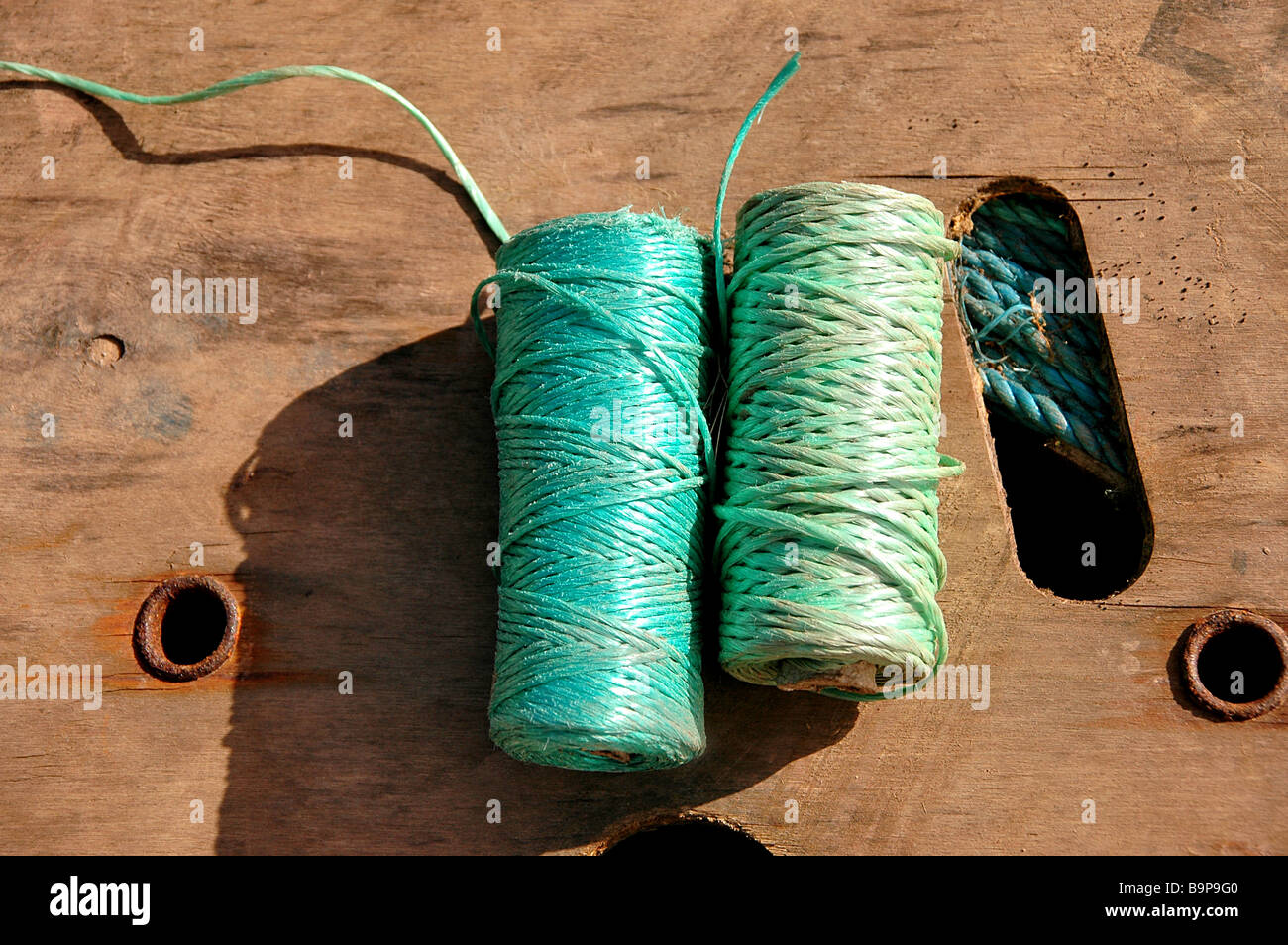 two spools of twine sit on an empty wooden fruit box Stock Photo - Alamy