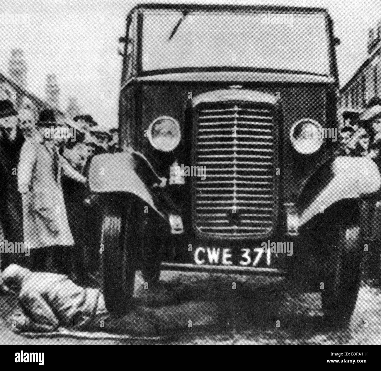 A truck loaded with coal going over the lying Russian athlete Alexander ...
