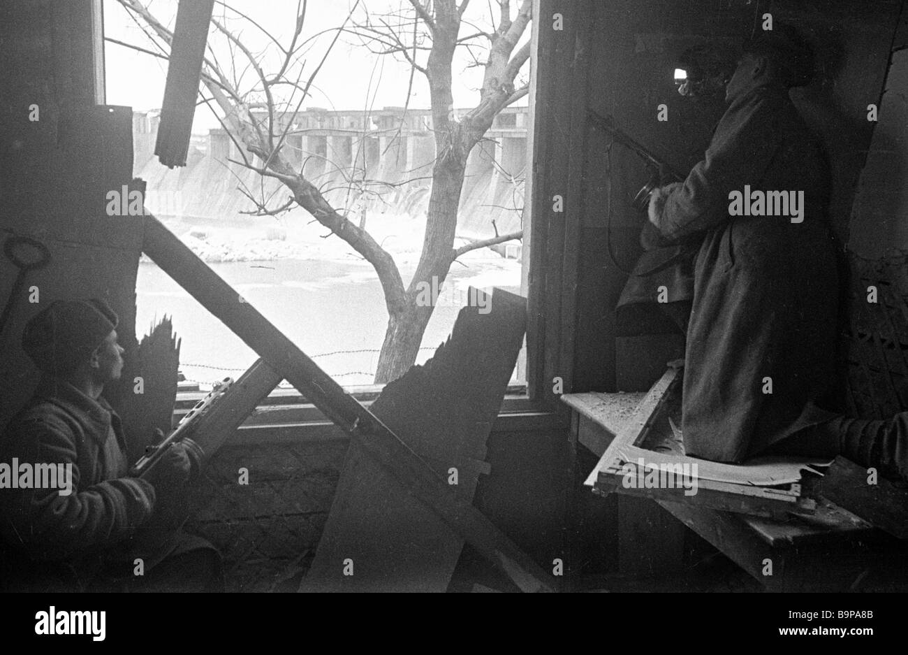 Two soldiers fighting in a destroyed house Its windows overlooking the ...