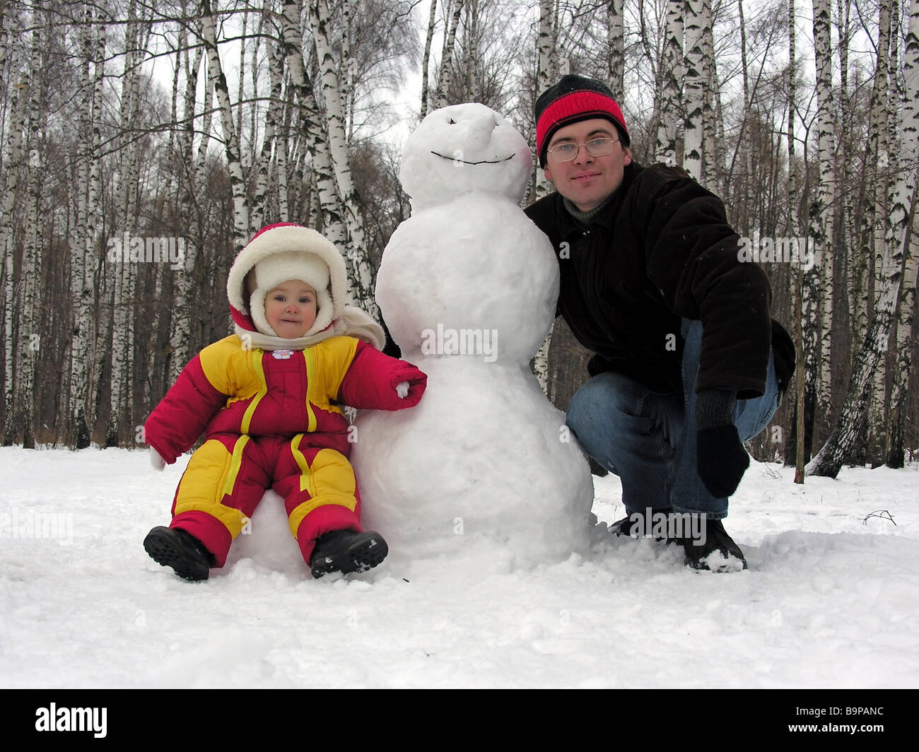 father, baby, snowman Stock Photo - Alamy