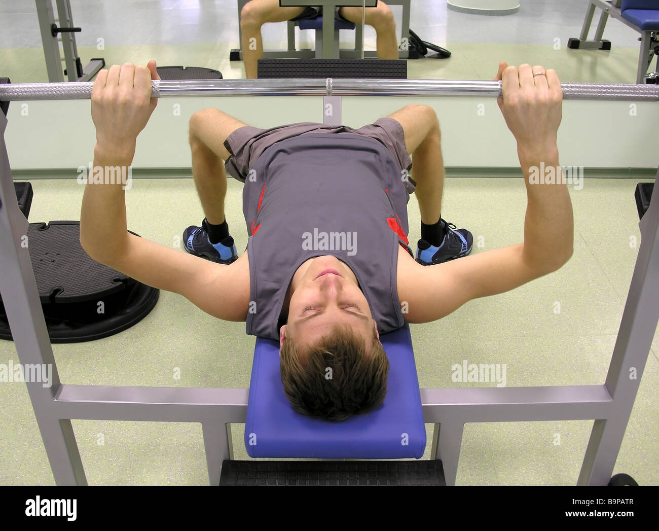 man in health club with barbell Stock Photo - Alamy