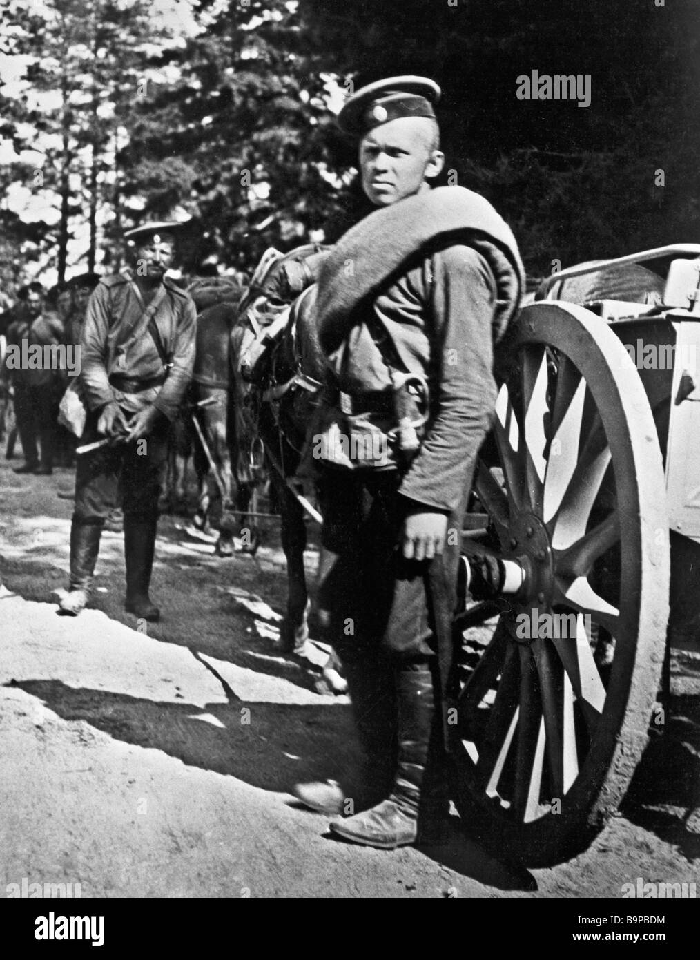 Sentry with greatcoat roll standing near cart during World War I Stock ...
