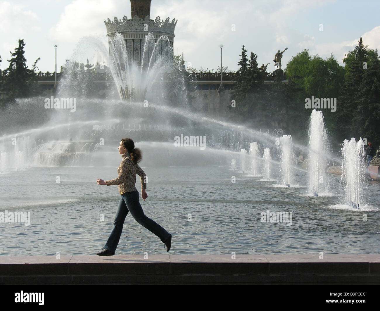 running girl at fountain Stock Photo - Alamy