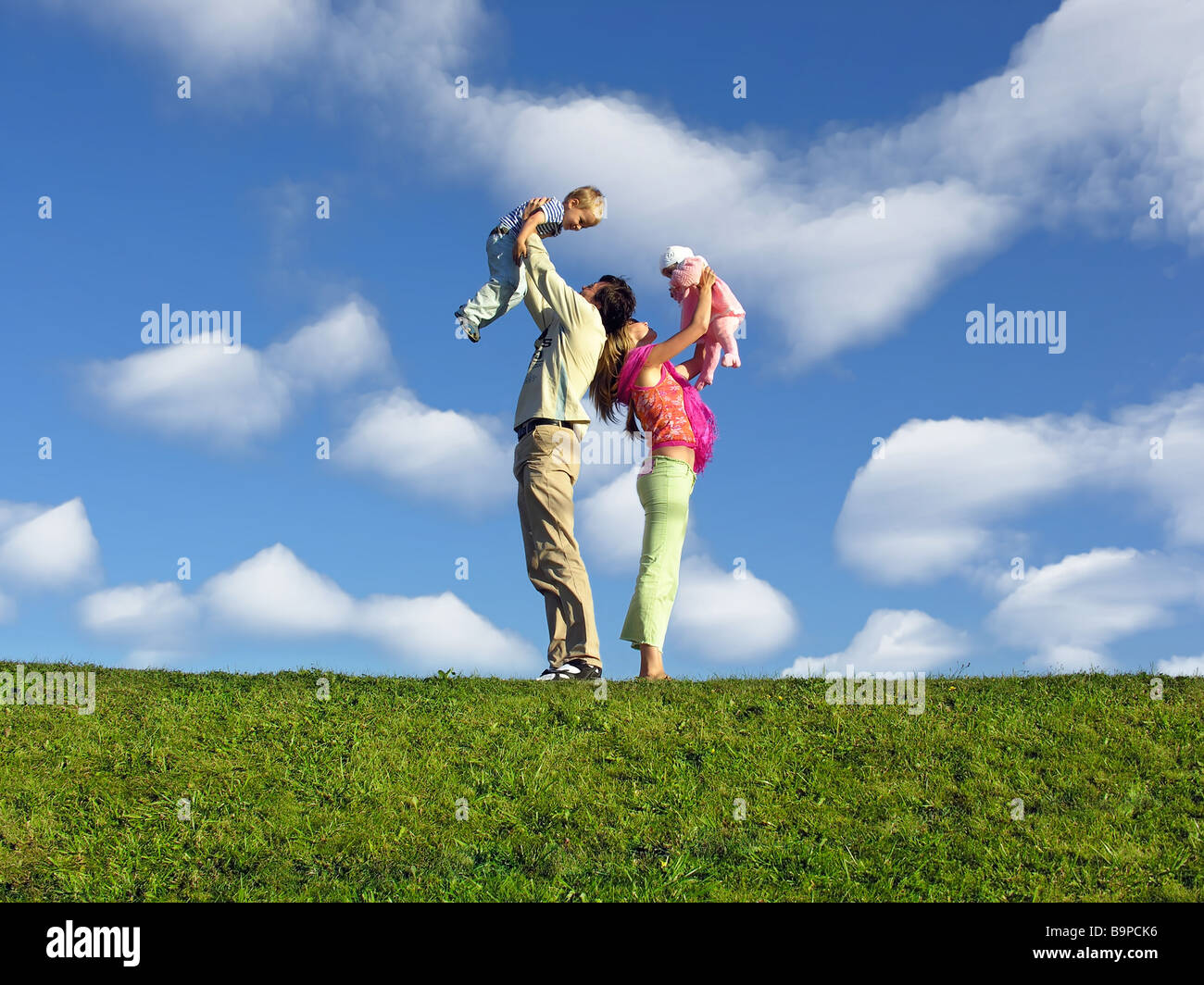 family with two children under clouds Stock Photo - Alamy
