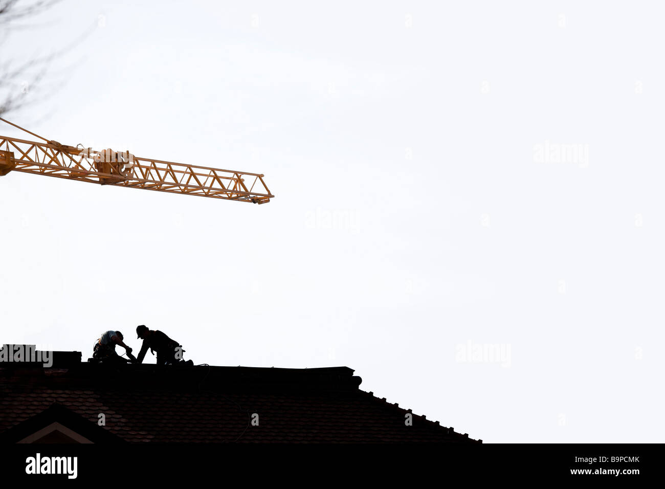 Abstract image of construction workers working on rooftop Stock Photo ...