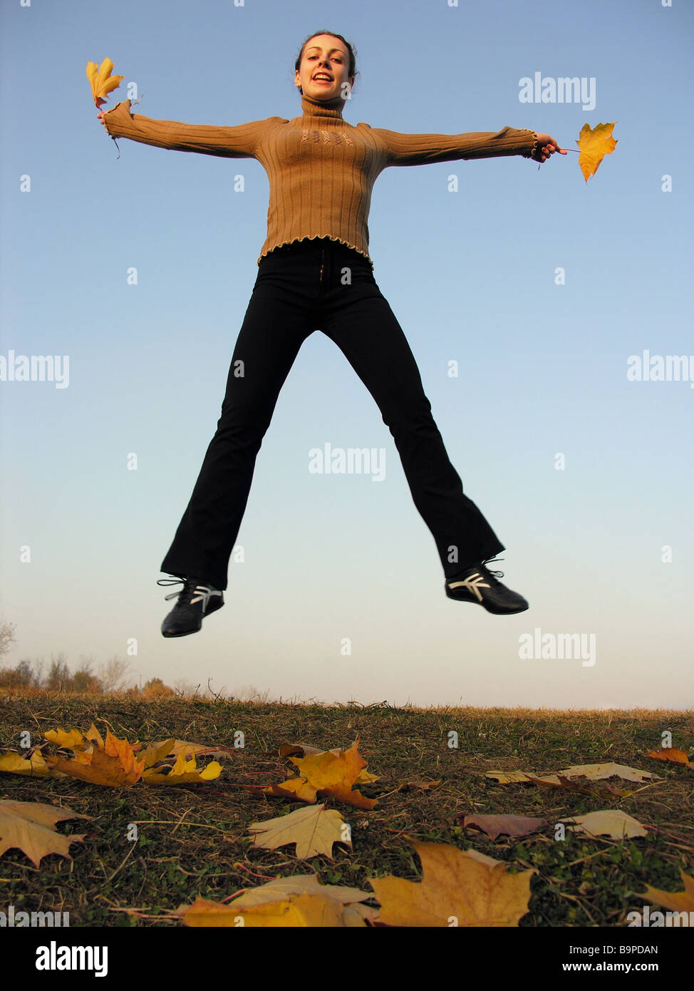 jump girl with autumn leaves Stock Photo - Alamy