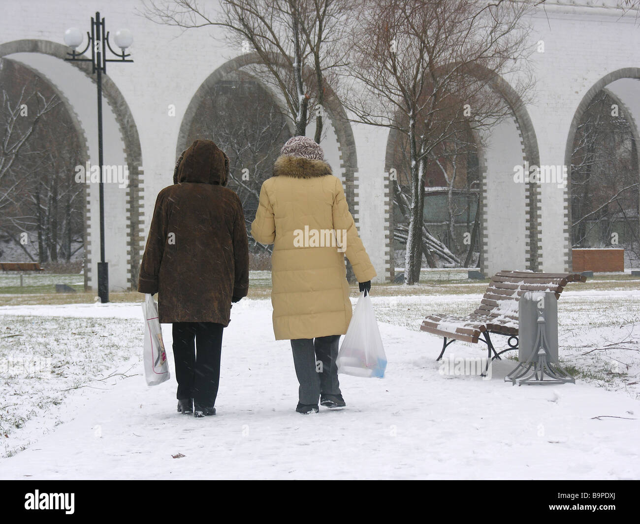 two woman's back. winter Stock Photo - Alamy
